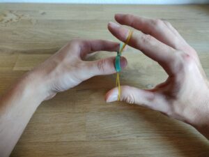 “Crazy Man’s Handcuffs”: Rubberband through rubberband trick