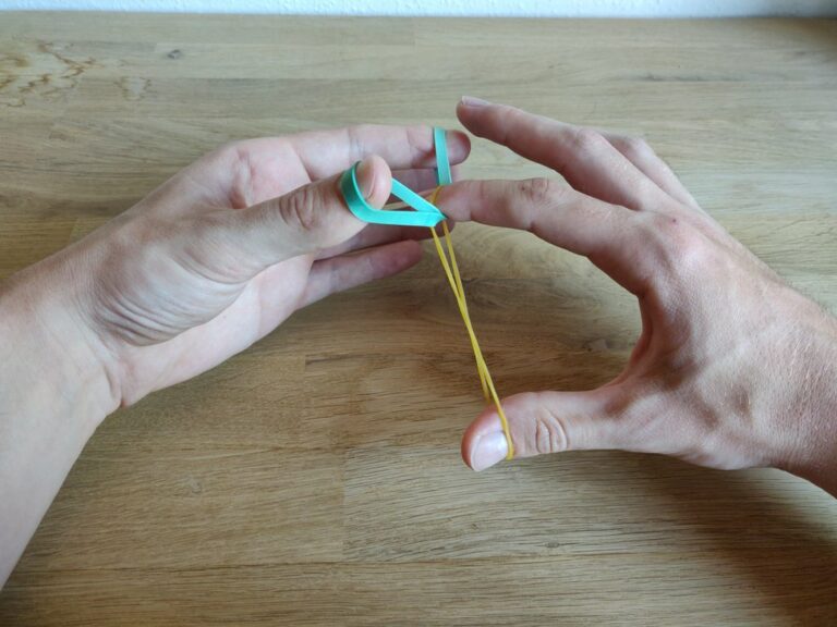 “Crazy Man’s Handcuffs”: Rubberband through rubberband trick