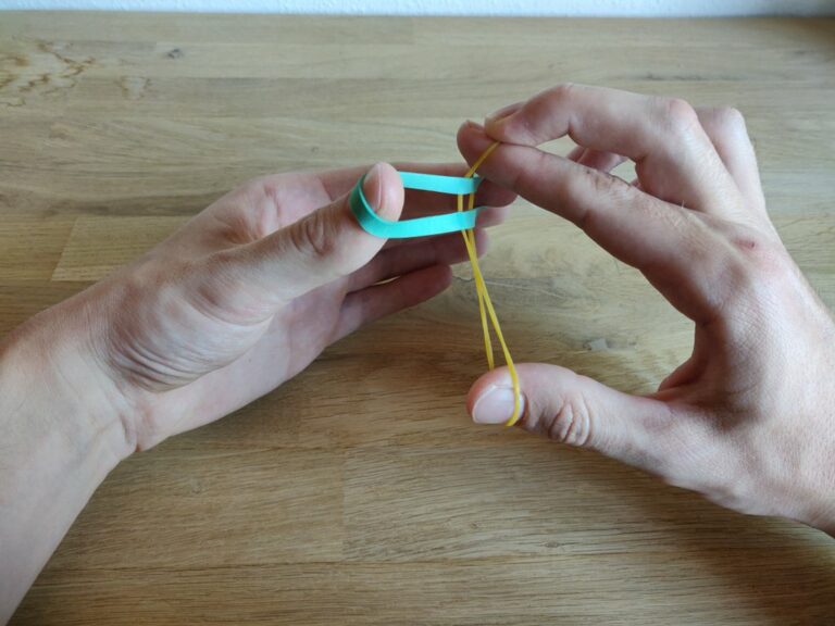 “Crazy Man’s Handcuffs”: Rubberband through rubberband trick