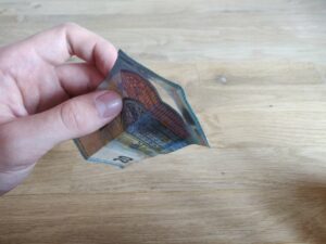 Magic trick with pen and dollar bill explained (with images)