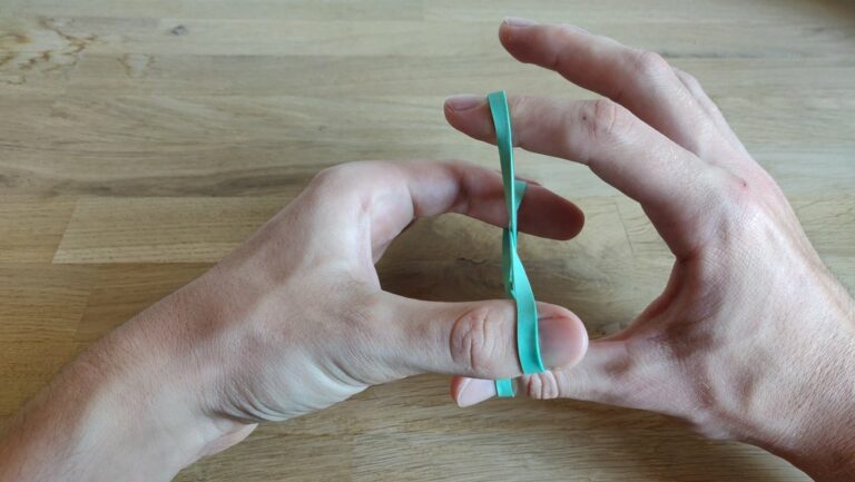 “Crazy Man’s Handcuffs”: Rubberband through rubberband trick